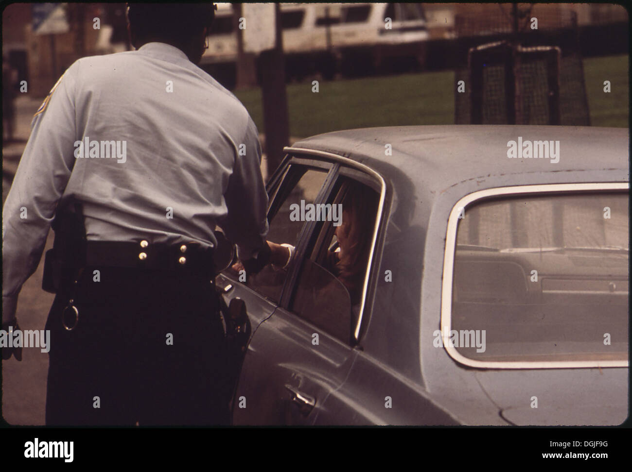 A law enforcement officer apprehends a traffic violator, emphasizing ...