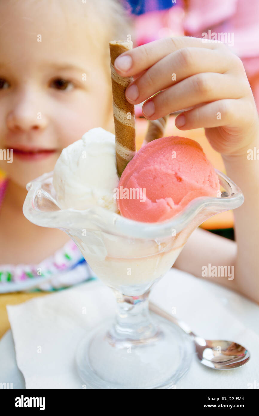 Little girl enjoying ice cream with crispy cream stick Stock Photo - Alamy