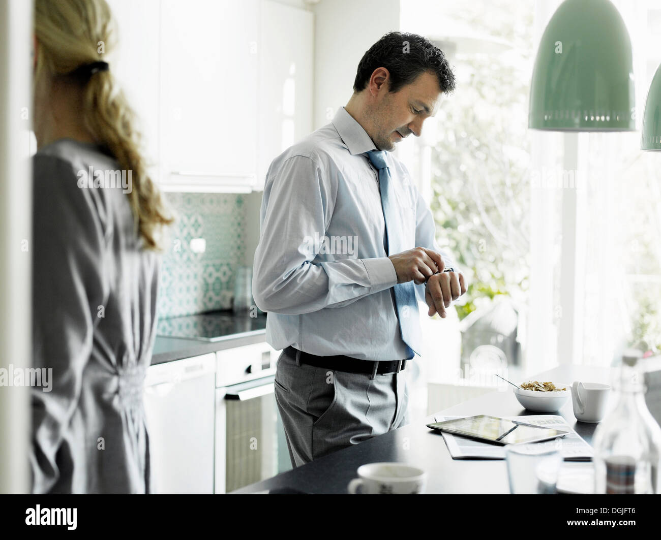 Smart businessman checking time in hi-res stock photography and images ...