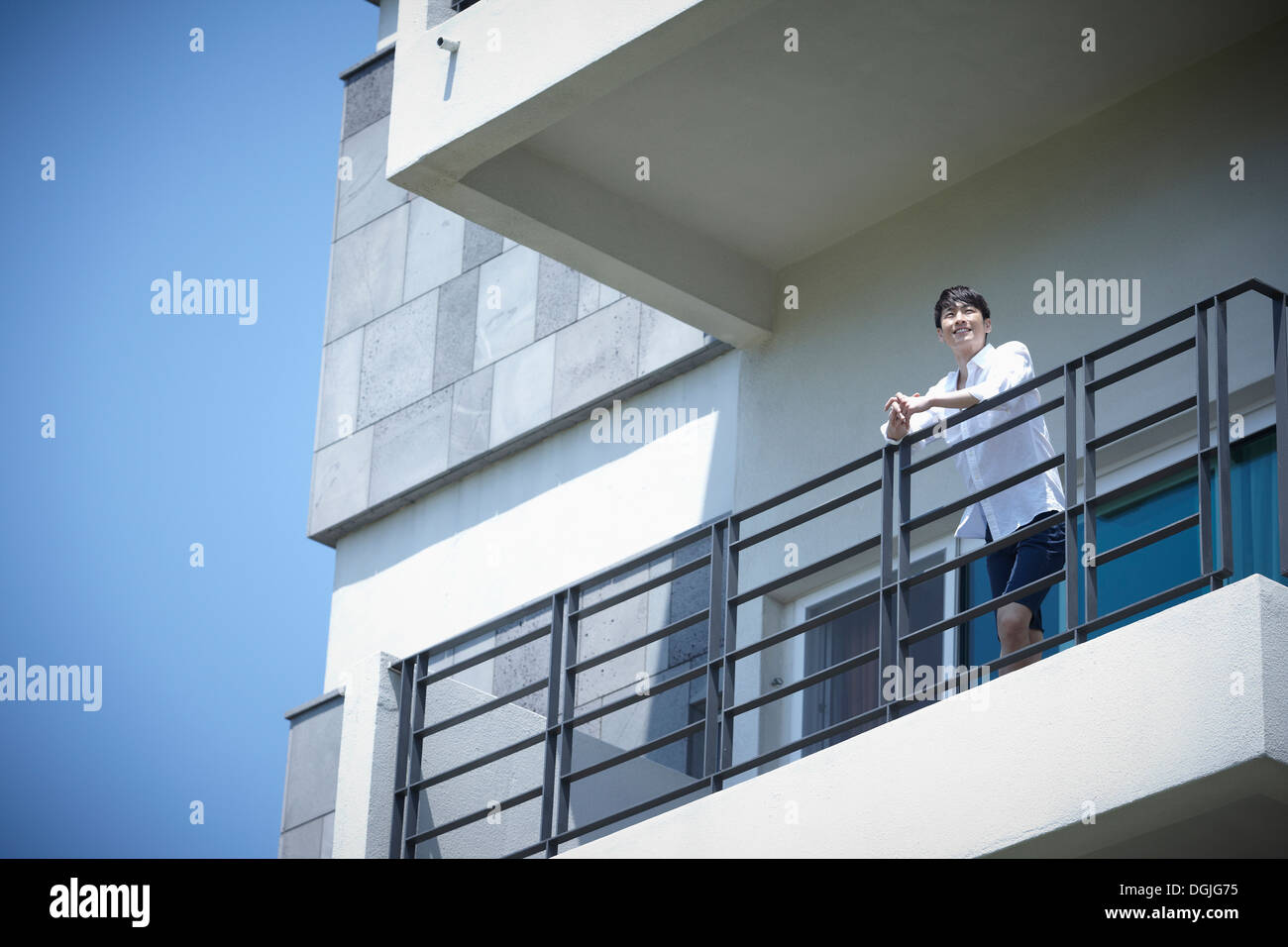 a man standing on a balcony Stock Photo - Alamy