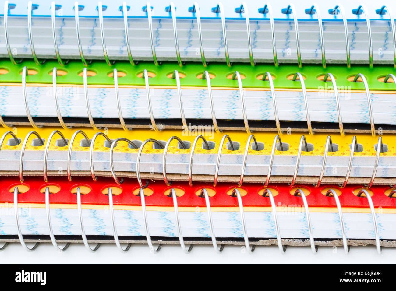 Multicolored spiral notebooks on a white background Stock Photo - Alamy