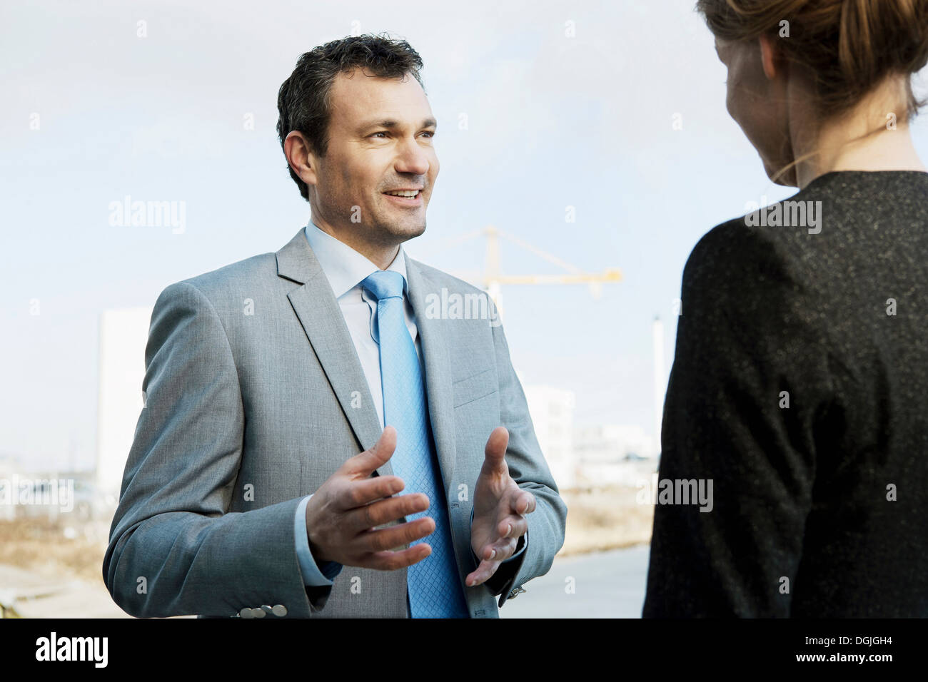 Mature businessman speaking to colleague outdoors Stock Photo - Alamy