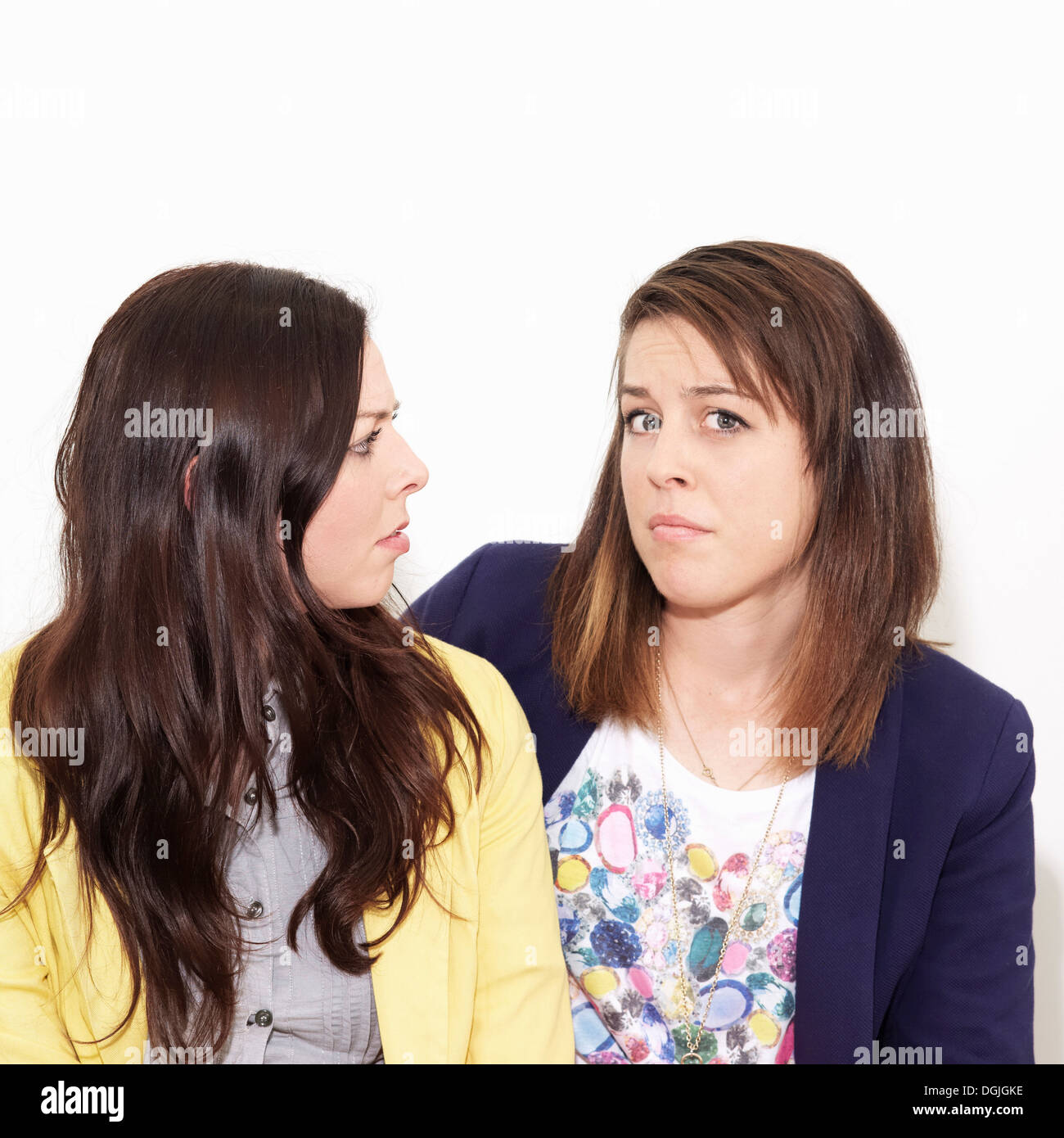 Young women arguing against white background Stock Photo - Alamy
