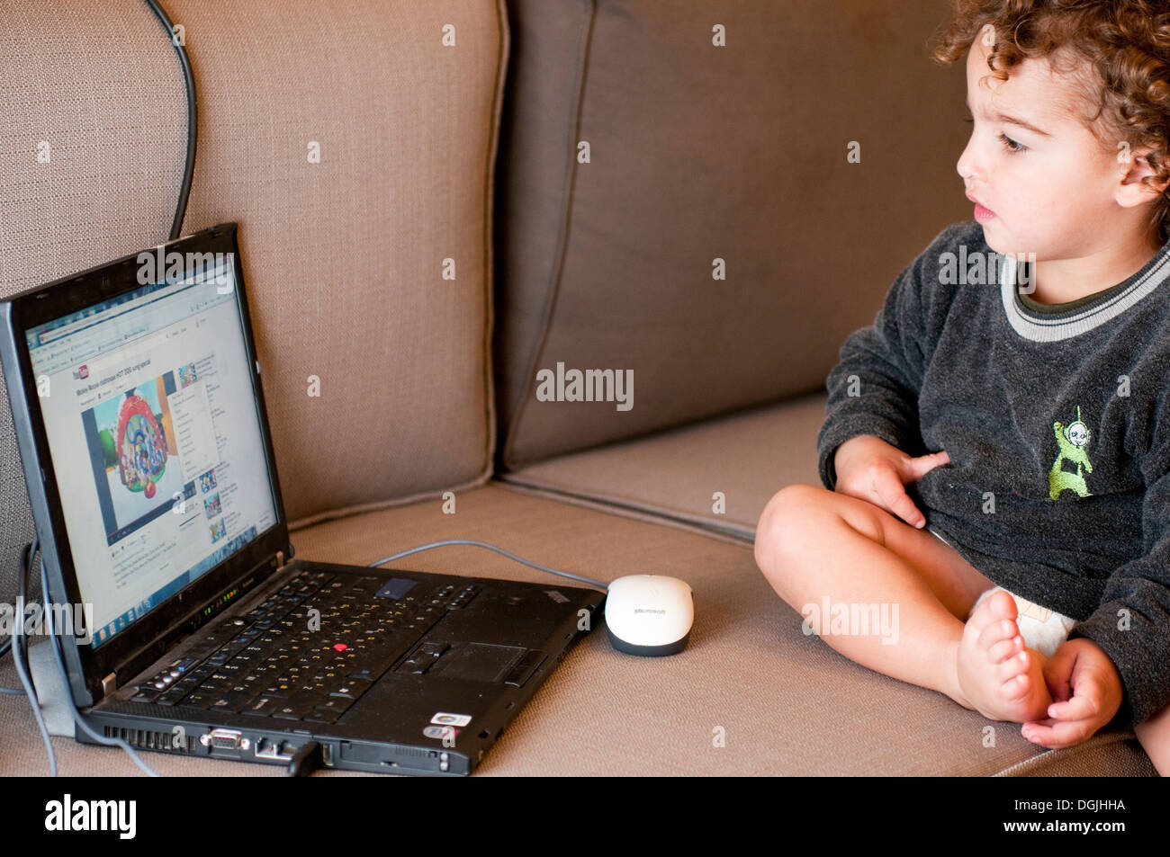 Toddler plays with a laptop computer Stock Photo - Alamy