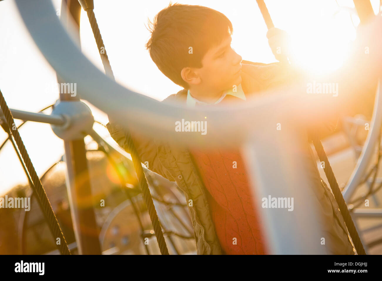 Boy on rope swing in playground Stock Photo - Alamy