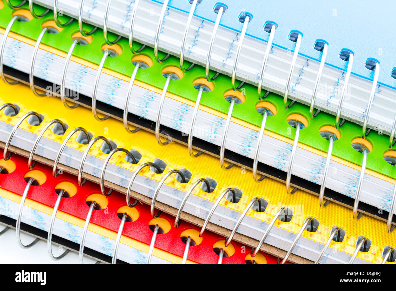Multicolored spiral notebooks on a white background Stock Photo - Alamy