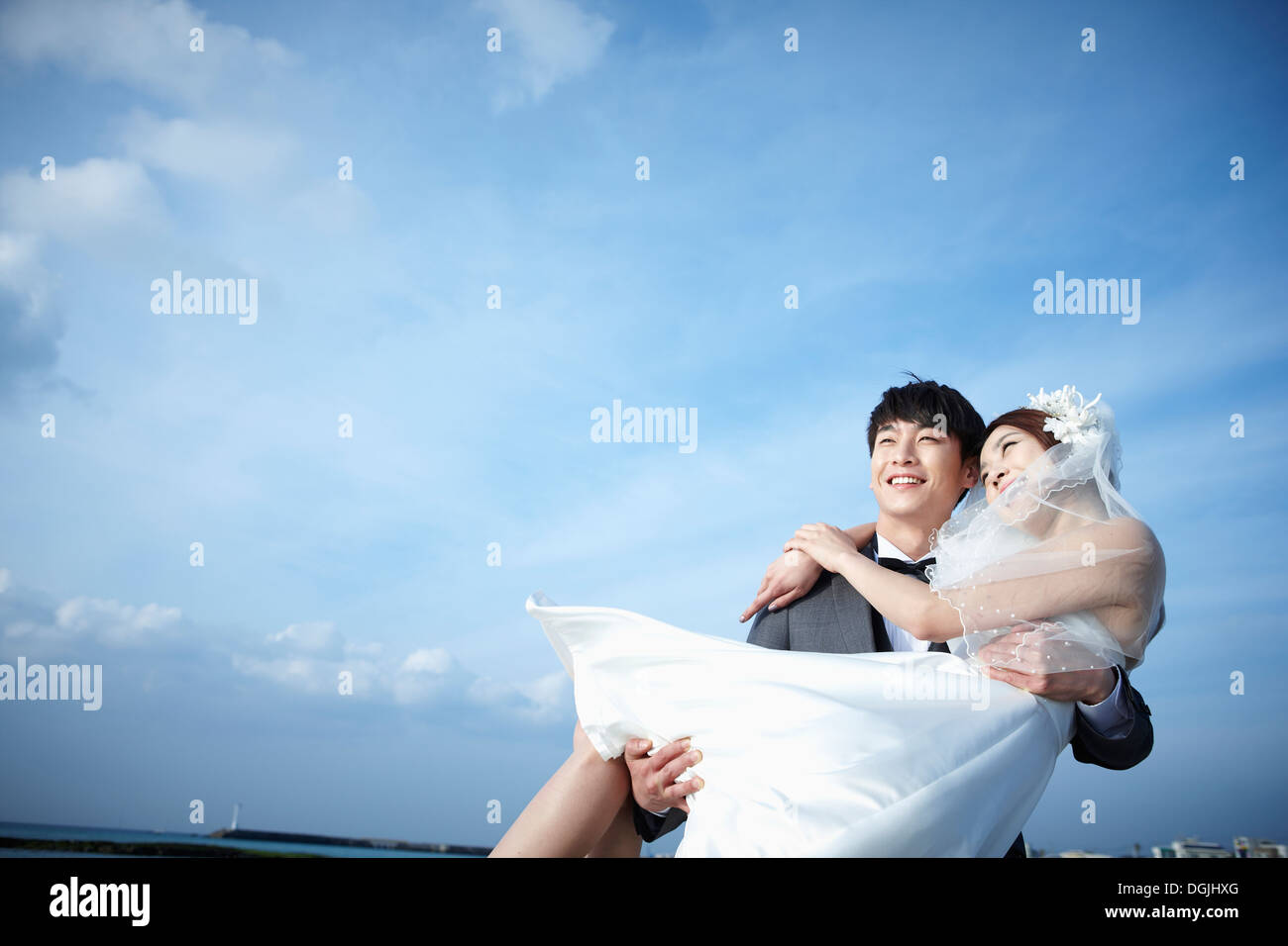 Bridegroom carrying bride hi-res stock photography and images - Alamy