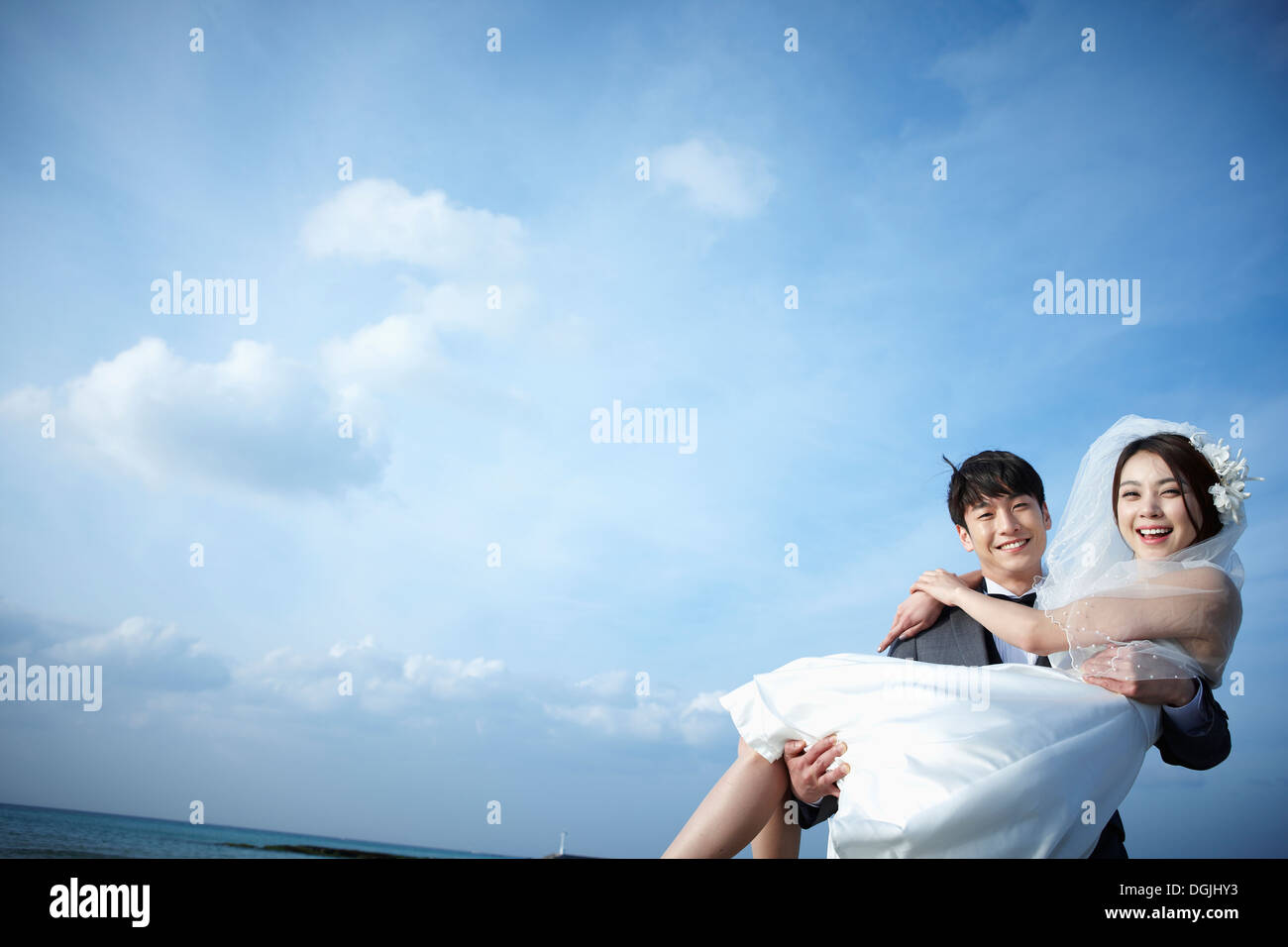 Bridegroom carrying bride hi-res stock photography and images - Alamy