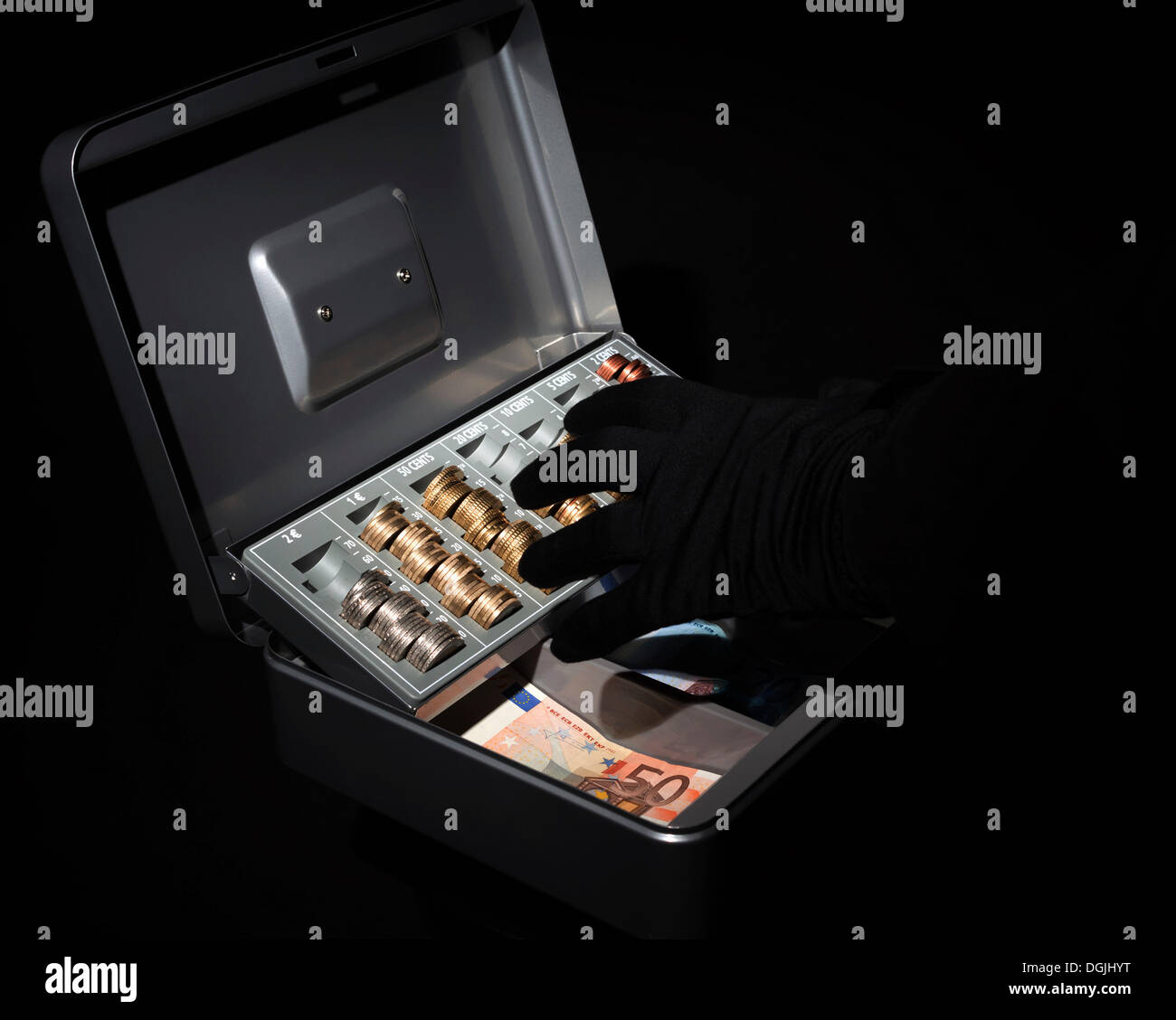 Hand wearing a black glove reaching for money, euro coins and euro ...