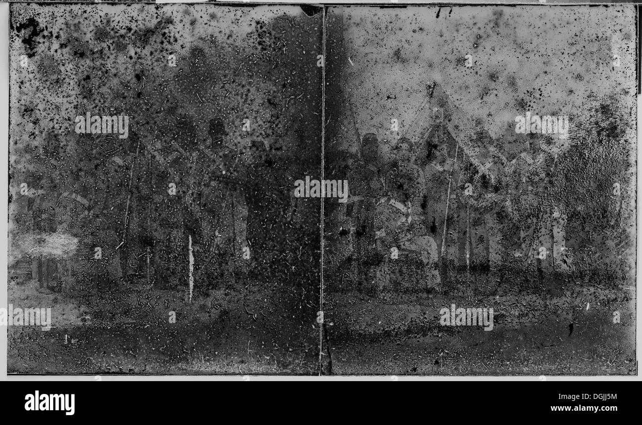 A group of soldiers gathered at a tent during a military campaign. The ...