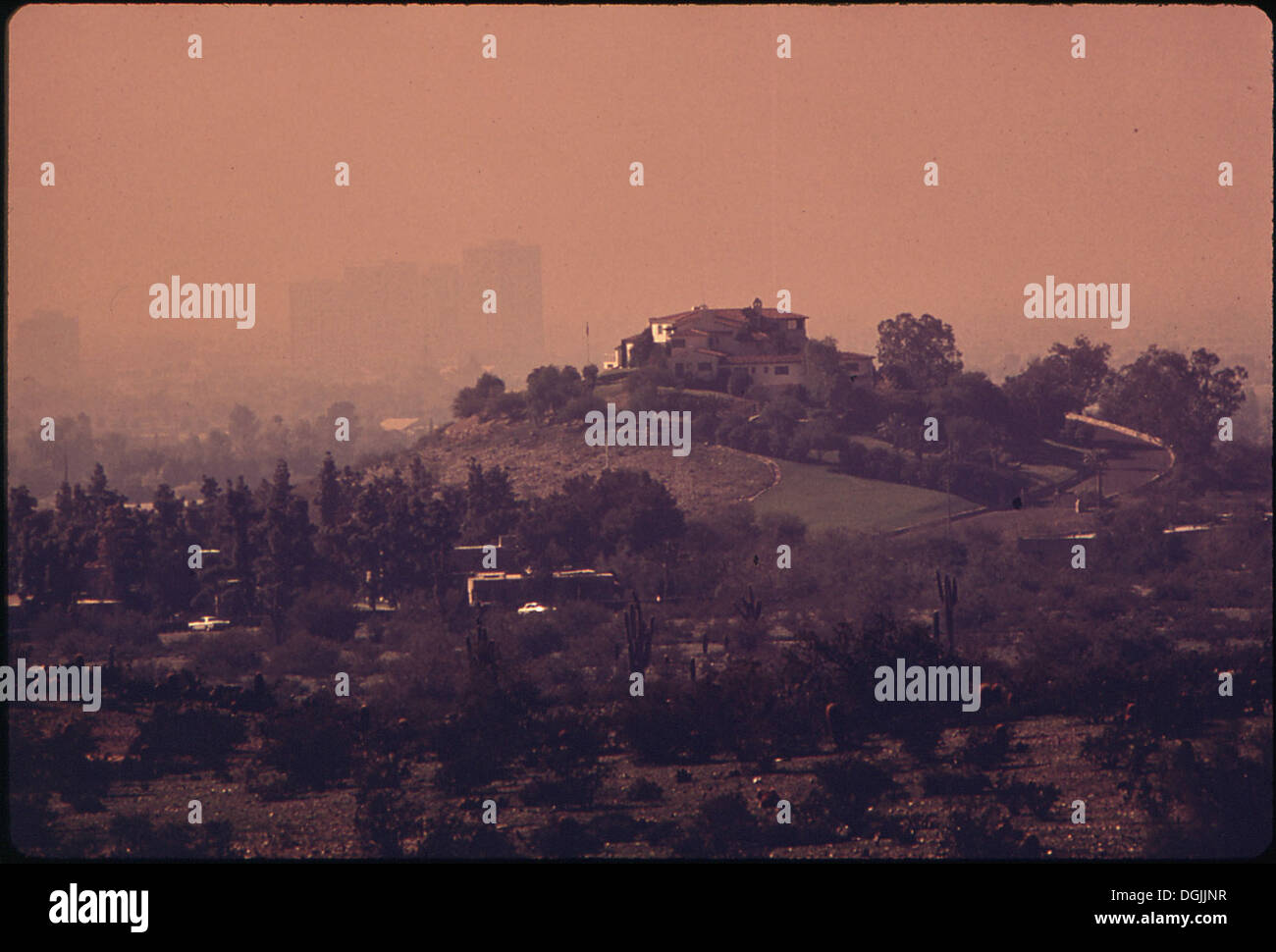 A photograph shows the thick smog over Phoenix, Arizona, highlighting ...