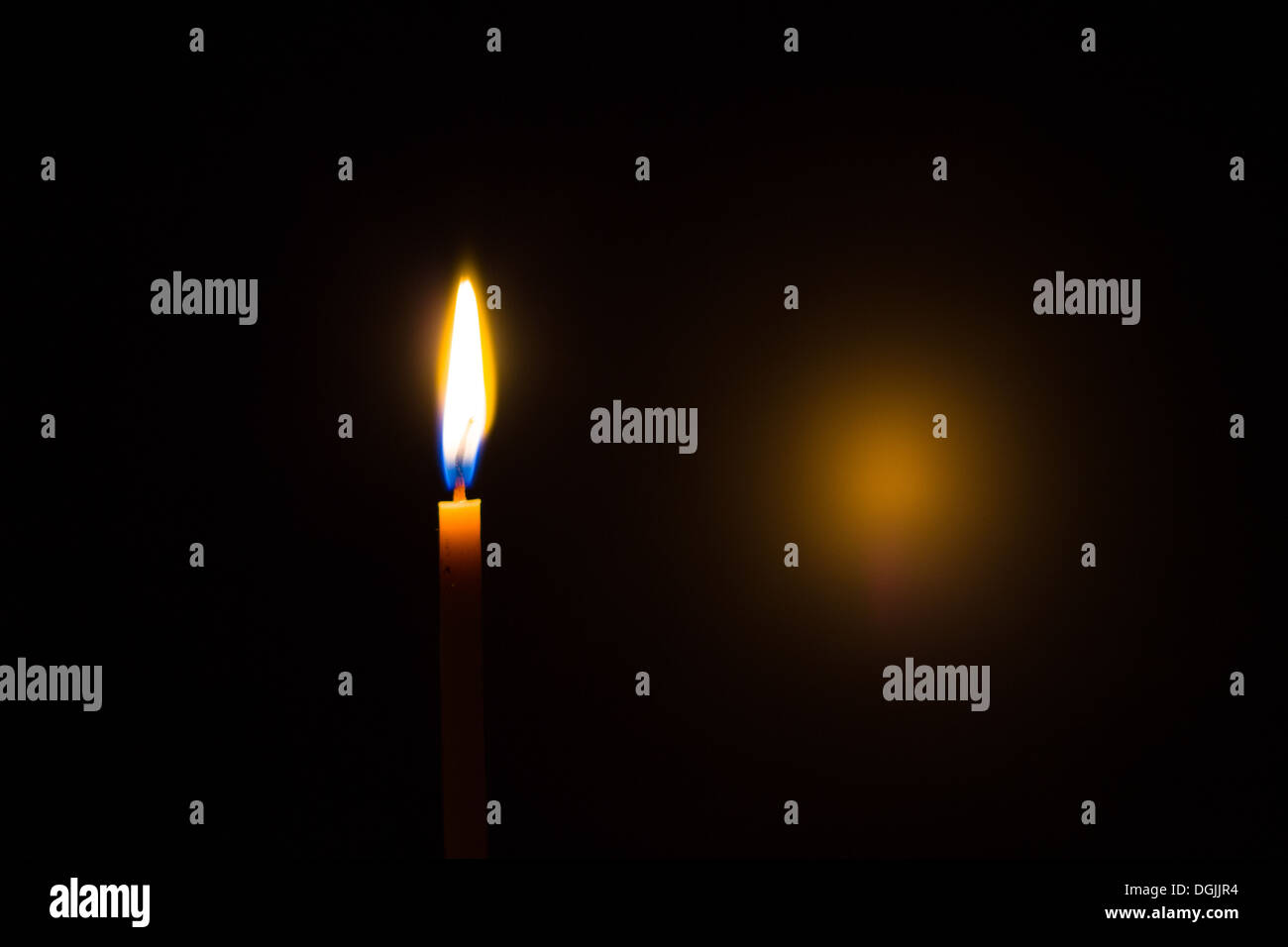 One candle flame at night closeup - isolated Stock Photo - Alamy