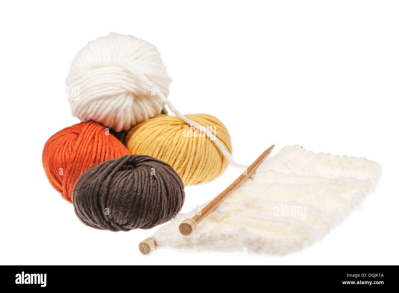 Three woll balls in white background with needles Stock Photo - Alamy