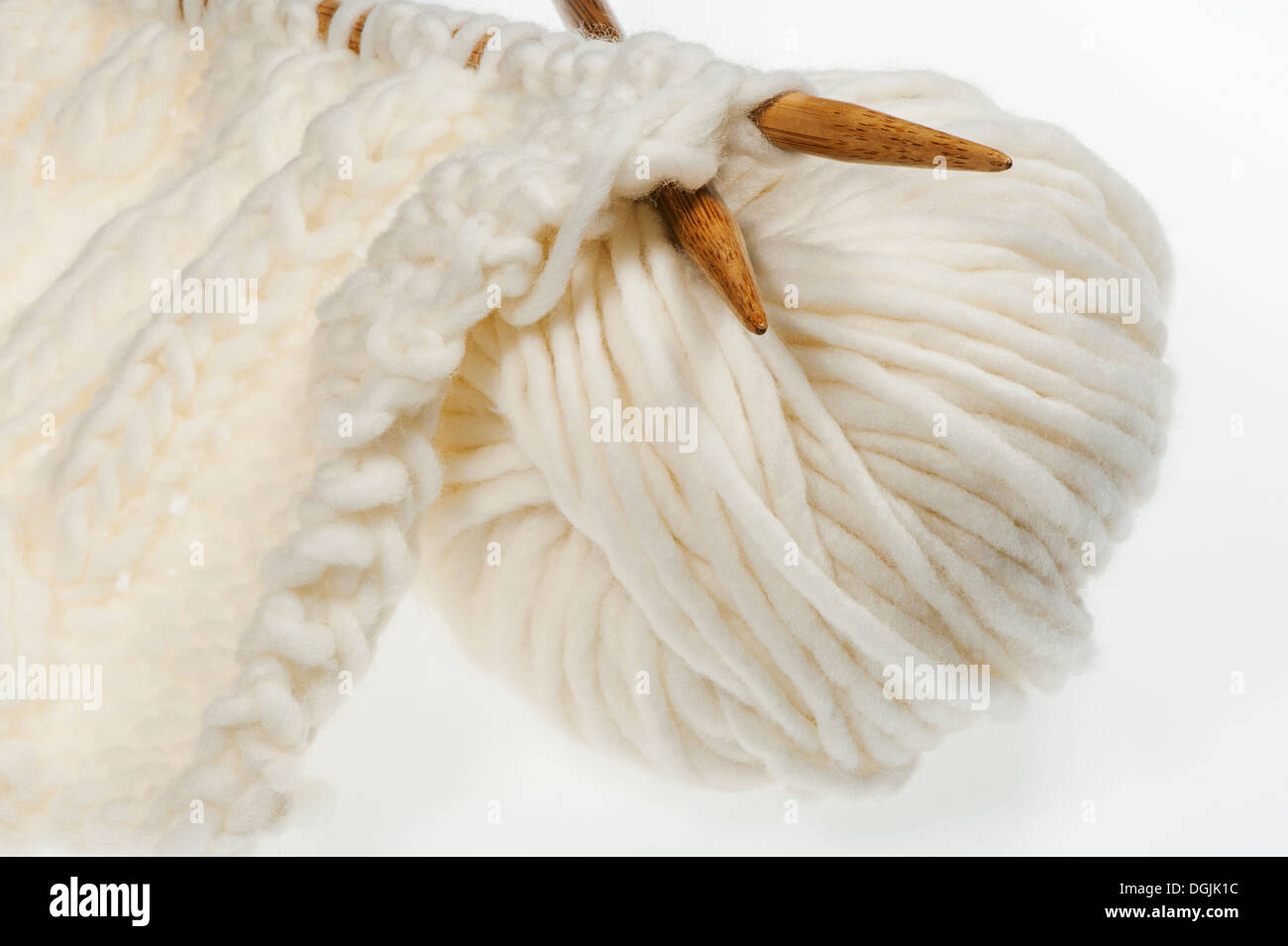 Three woll balls in white background with needles Stock Photo - Alamy