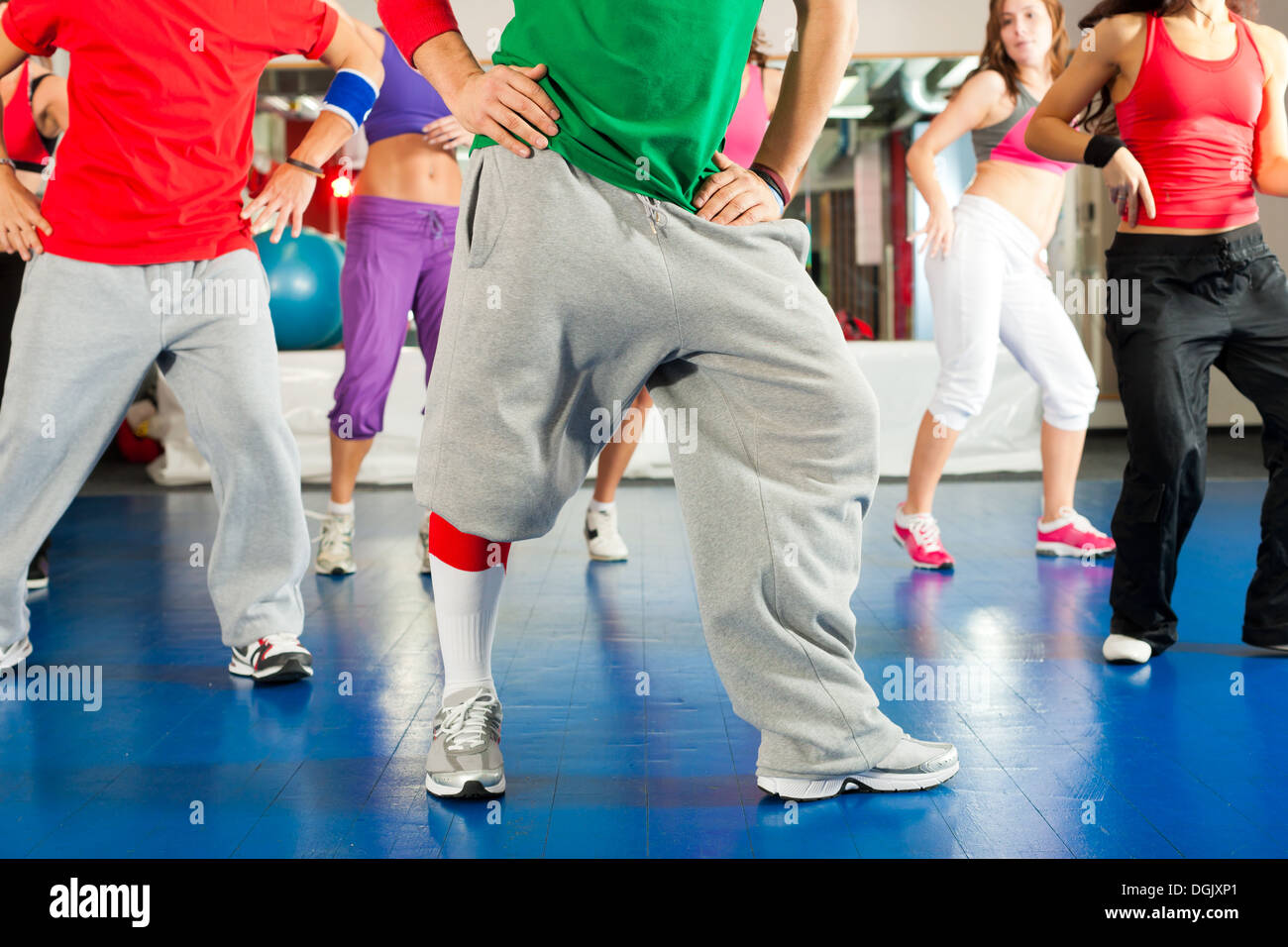 Fitness - Young people doing Zumba training or dance workout in a gym ...