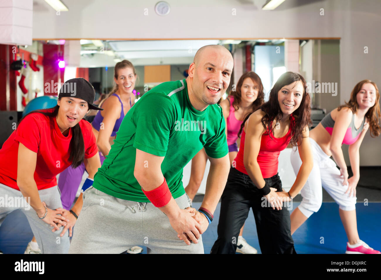 Fitness - Young people doing Zumba training or dance workout in a gym ...
