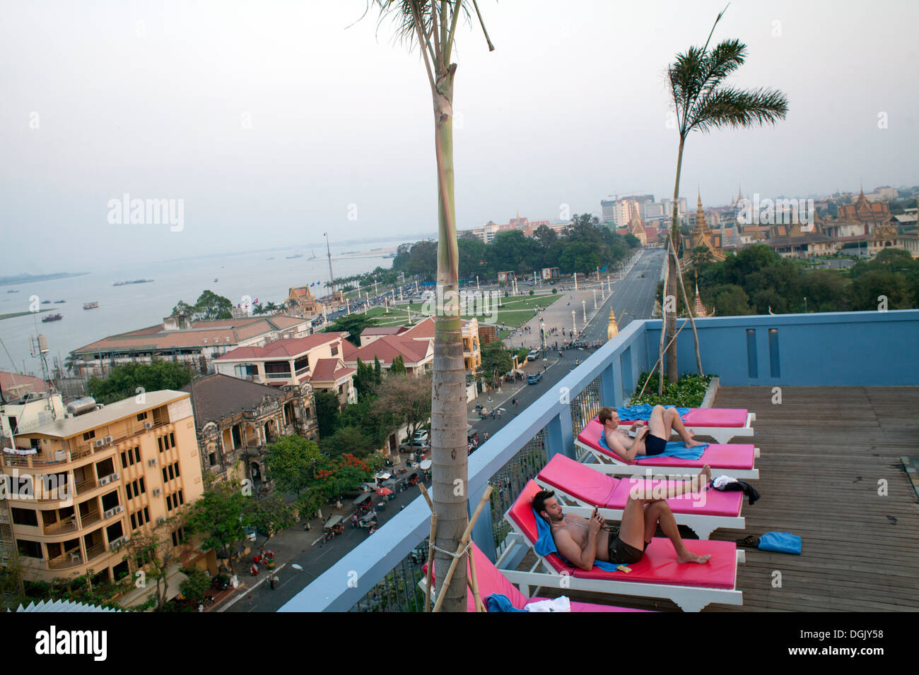 Tourists relax next to rooftop hotel pool in phnom penh hi-res stock ...
