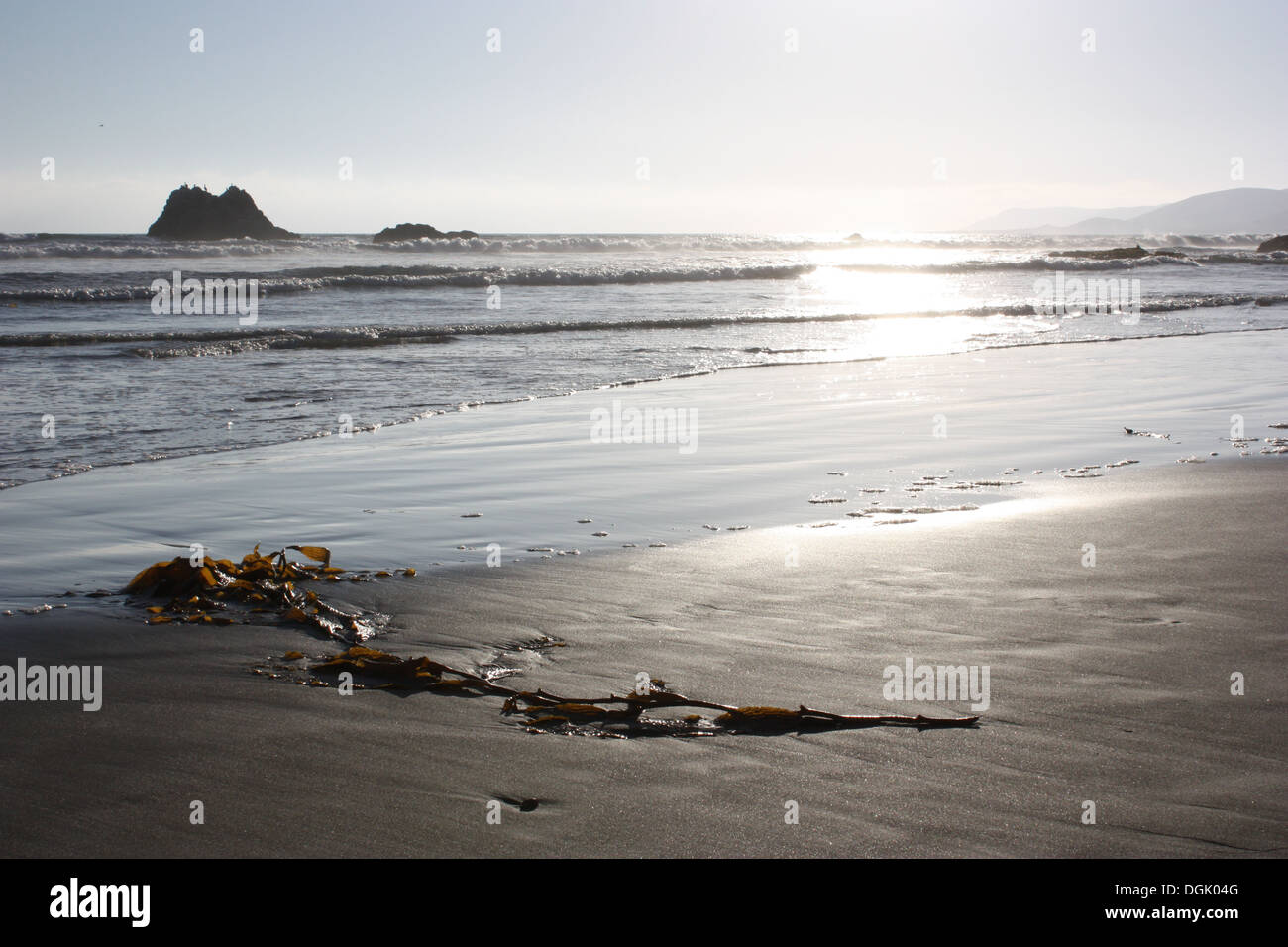 Sun setting over California beach Stock Photo - Alamy
