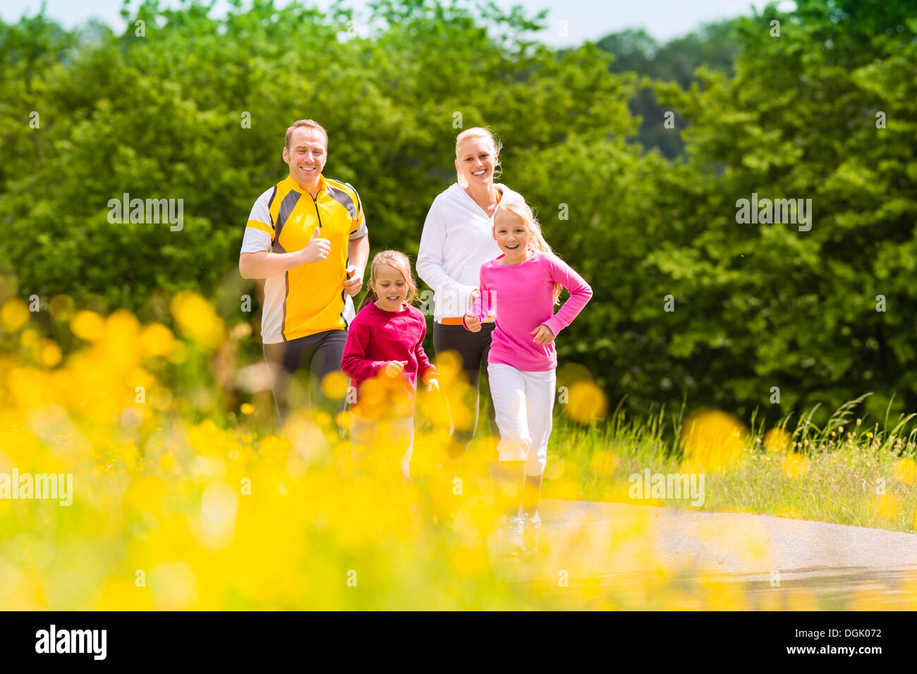 Happy Family with two girls running or jogging for sport and better ...