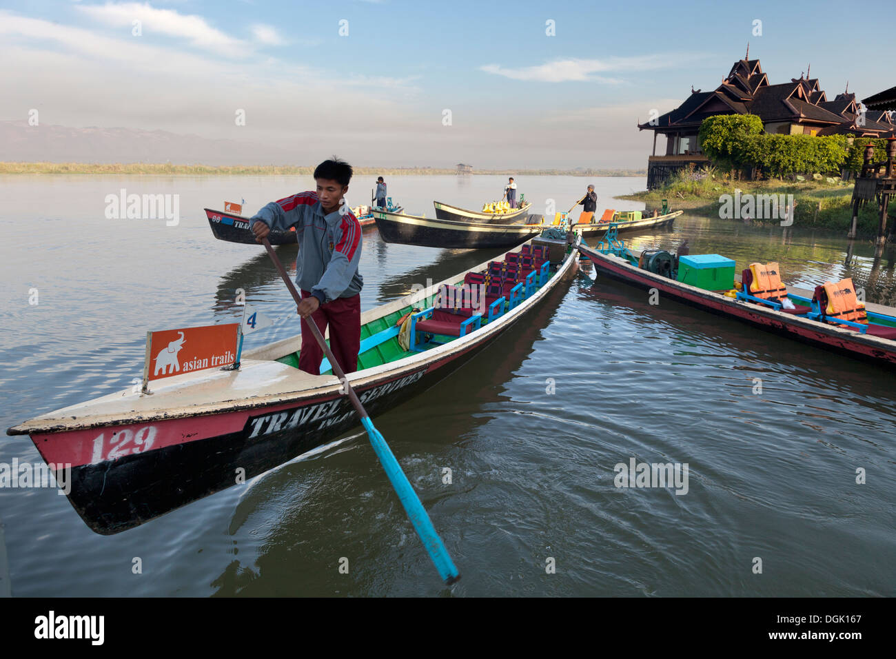 Boats moored by the Lake Inle Resort at sunset in Myanmar Stock Photo ...