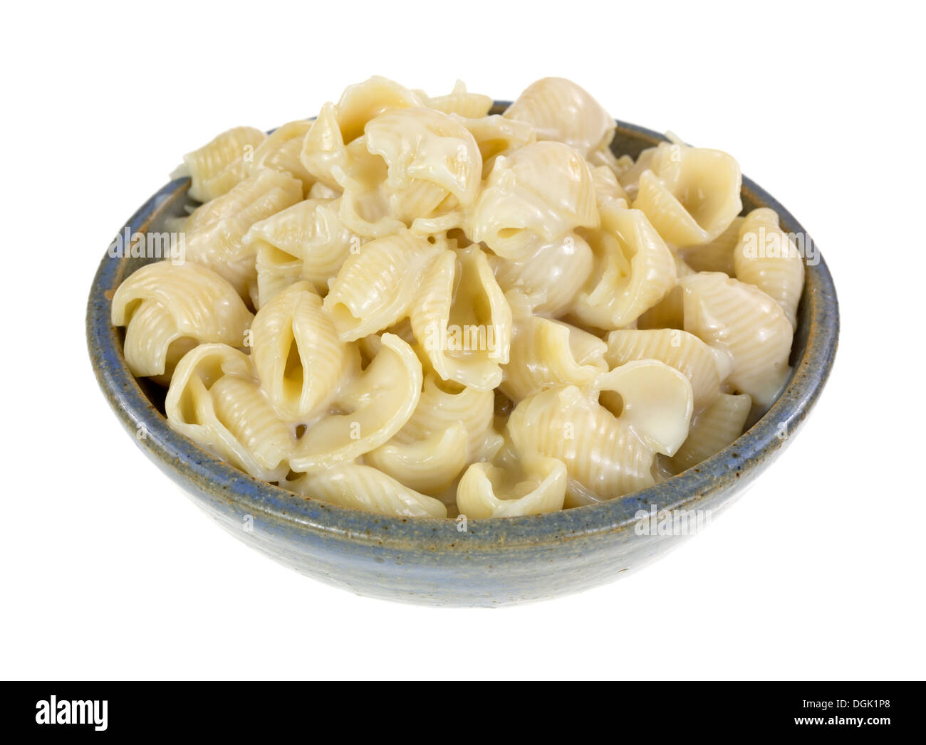 An old bowl filled with cooked pasta shells covered with a thick cheese ...