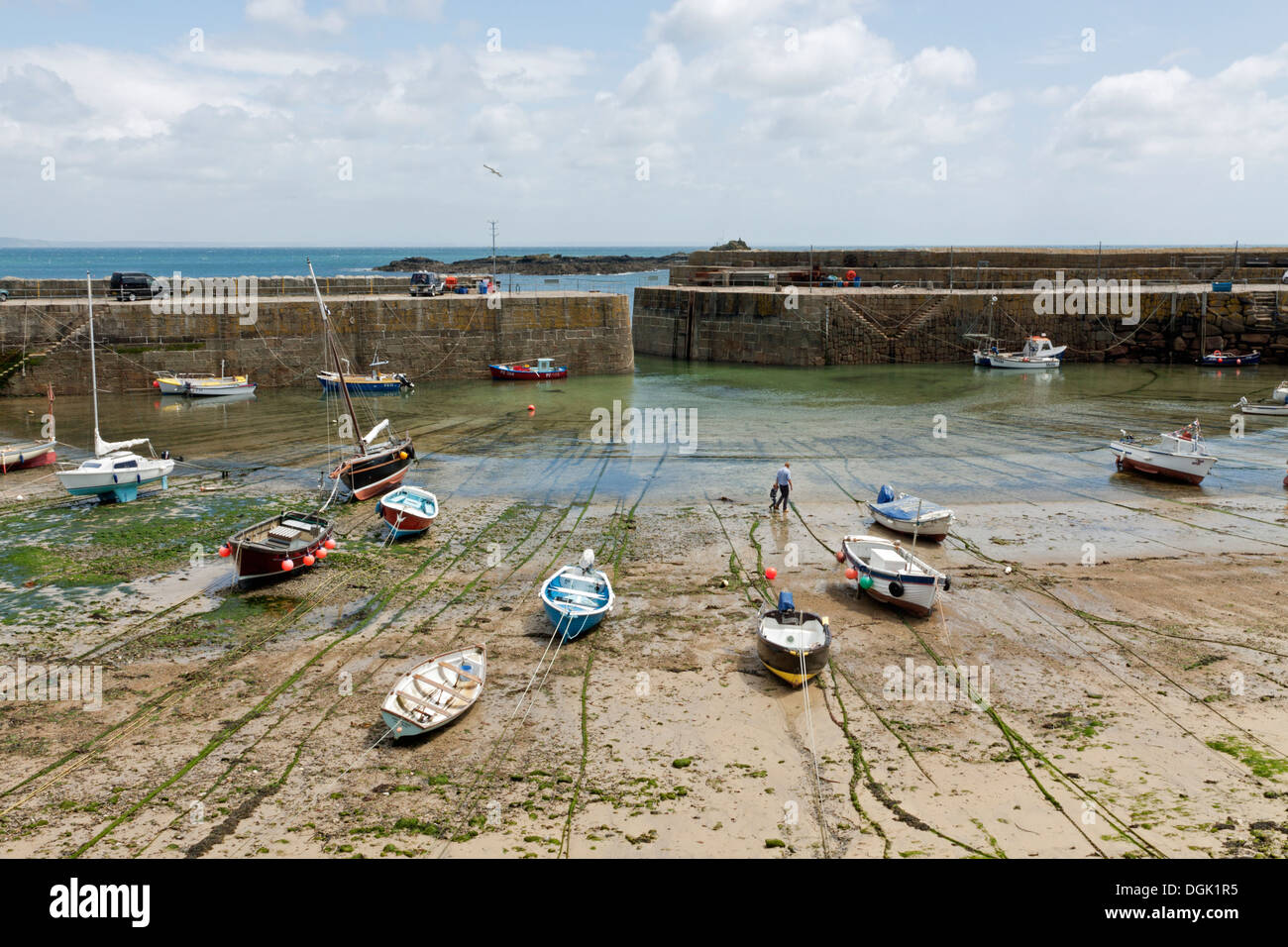 Man and boy enjoy low tide in Mousehole Harbour Cornwall Stock Photo ...