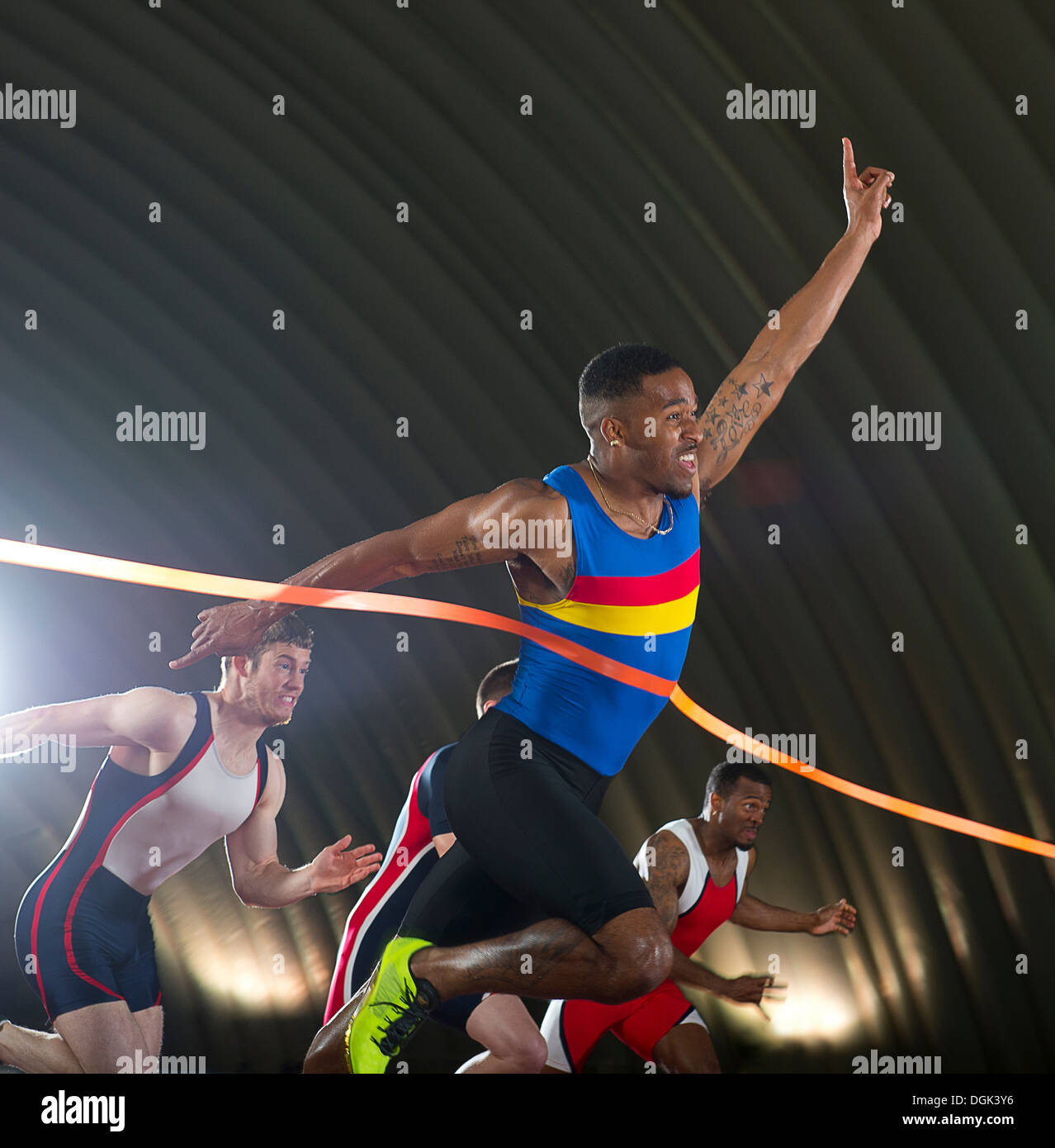 Athlete reaching finish line in race Stock Photo - Alamy