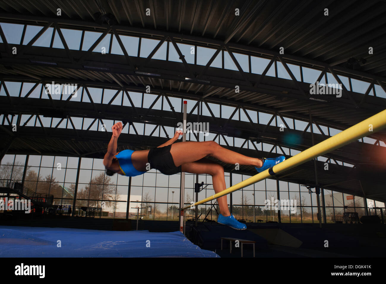 Young female athlete doing high jump Stock Photo - Alamy