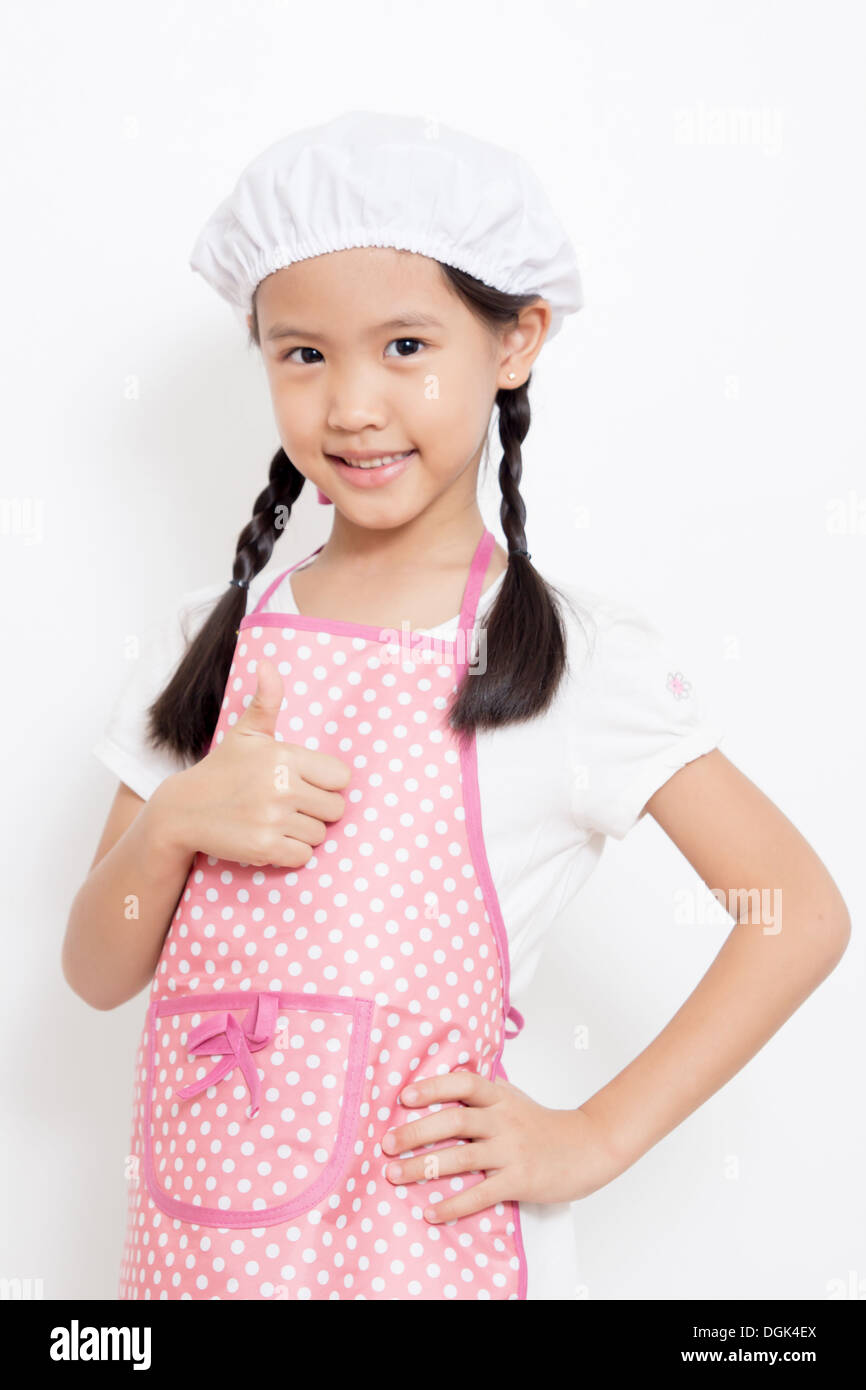 Pretty Asian cute chef wearing pink apron and thumb up Stock Photo - Alamy