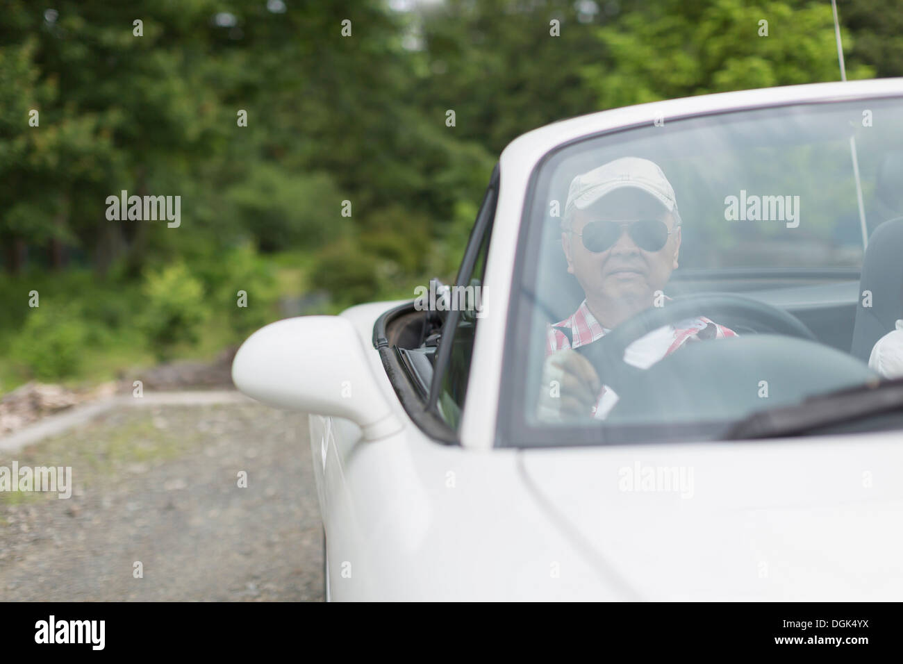 Man enjoying leisurely drive in sports car Stock Photo - Alamy
