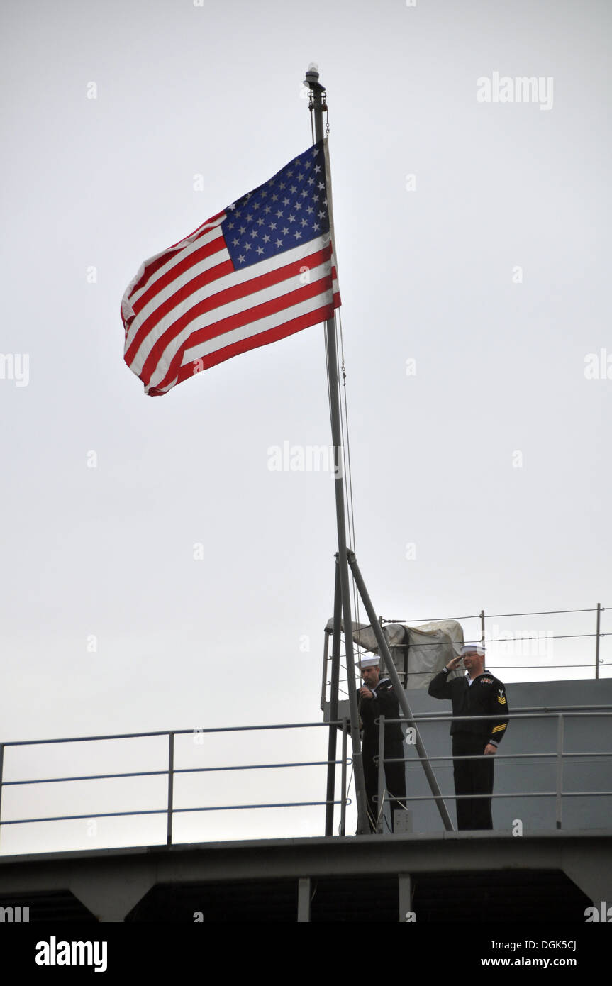A Sailor aboard the submarine tender USS Frank Cable (AS 40) renders ...