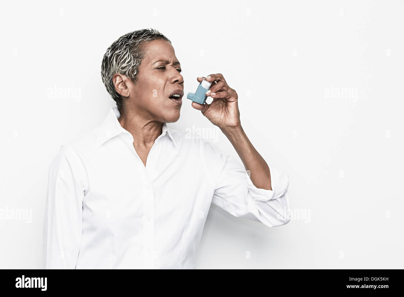 Senior woman using asthma inhaler Stock Photo - Alamy