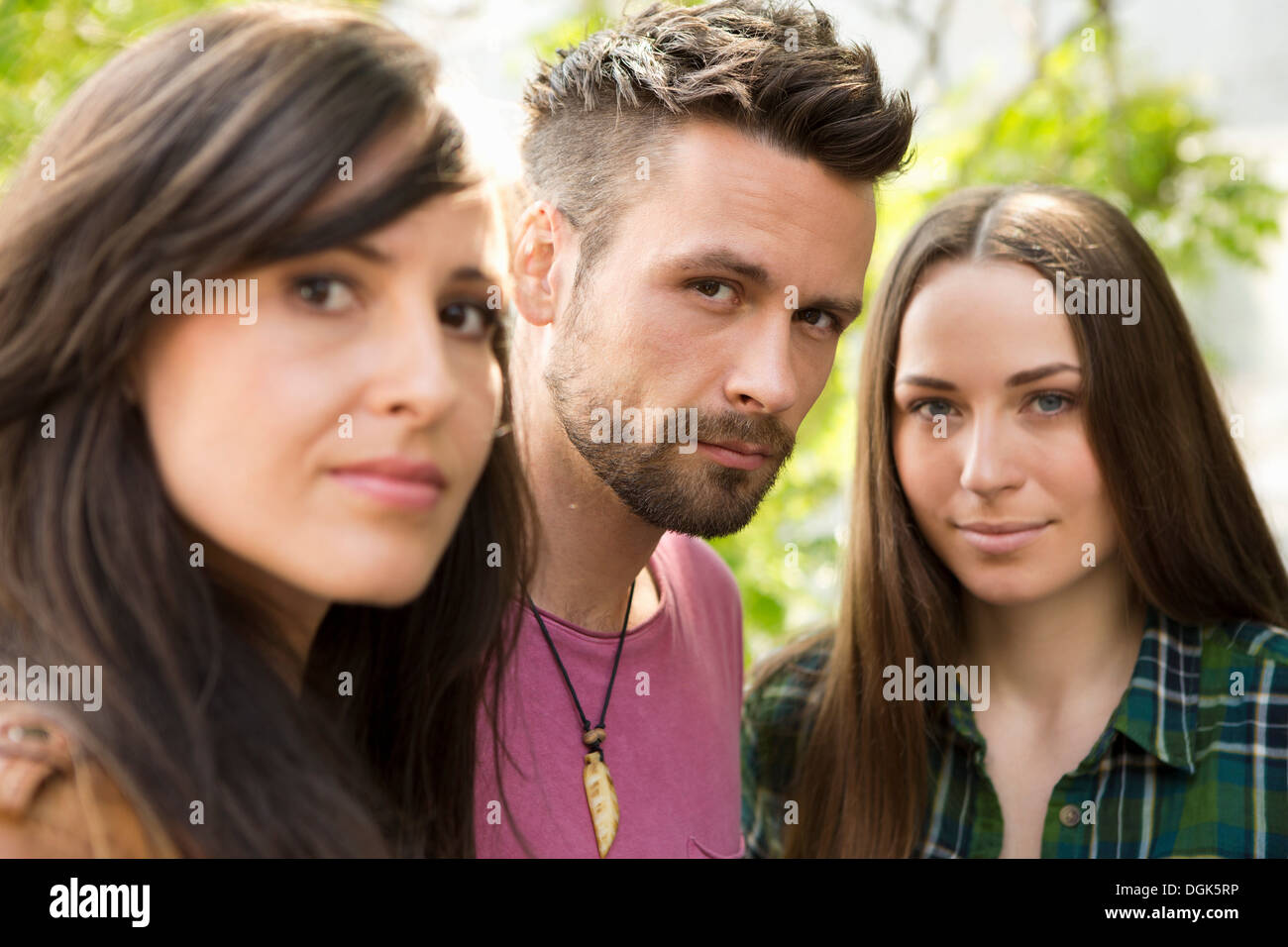 Three friends looking at camera Stock Photo - Alamy