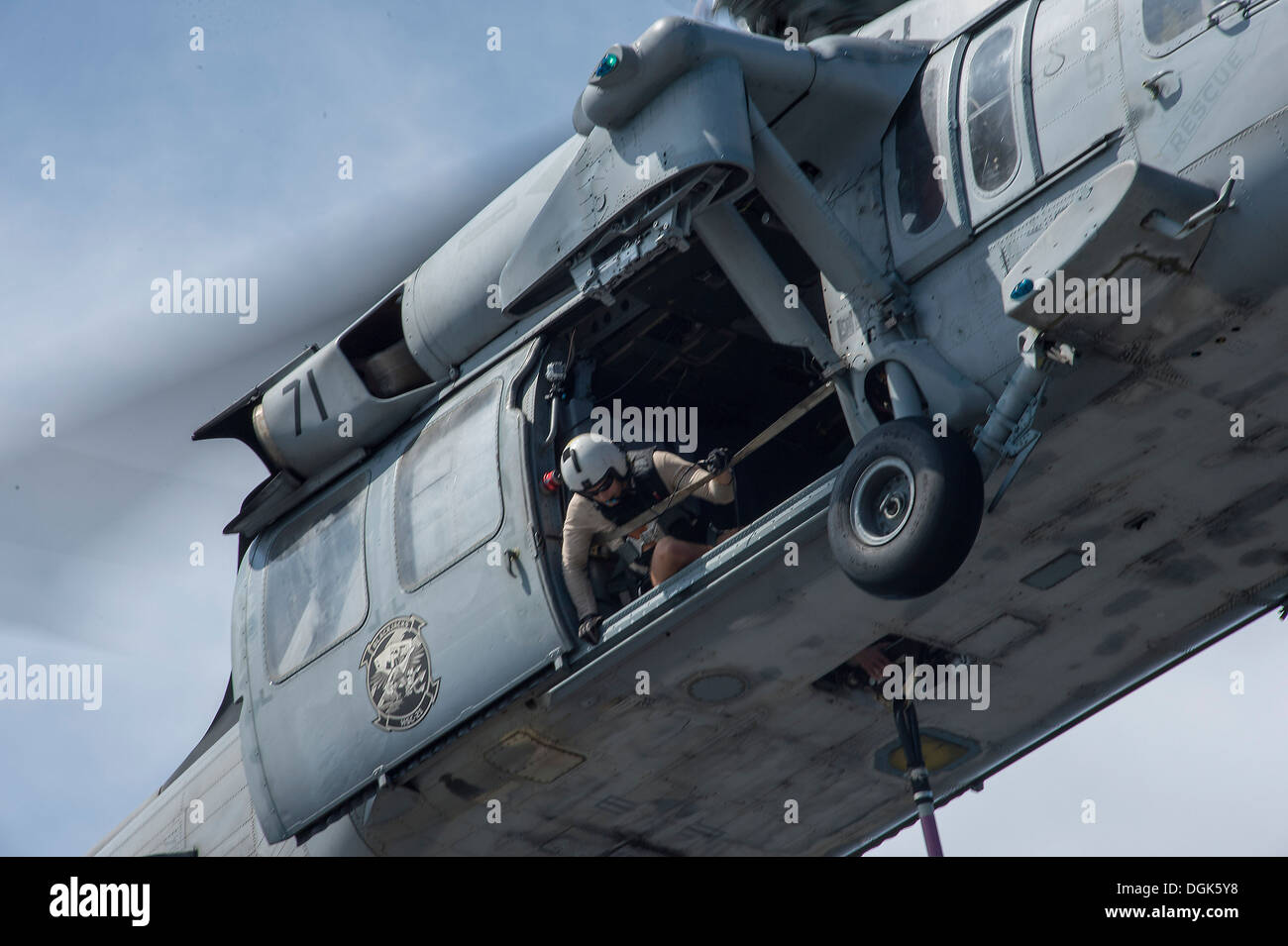 Naval Aircrewman (Helicopter) 3rd Class Benjamin McCracken acts as a ...