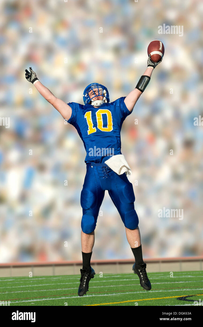 American footballer jumping with ball Stock Photo - Alamy