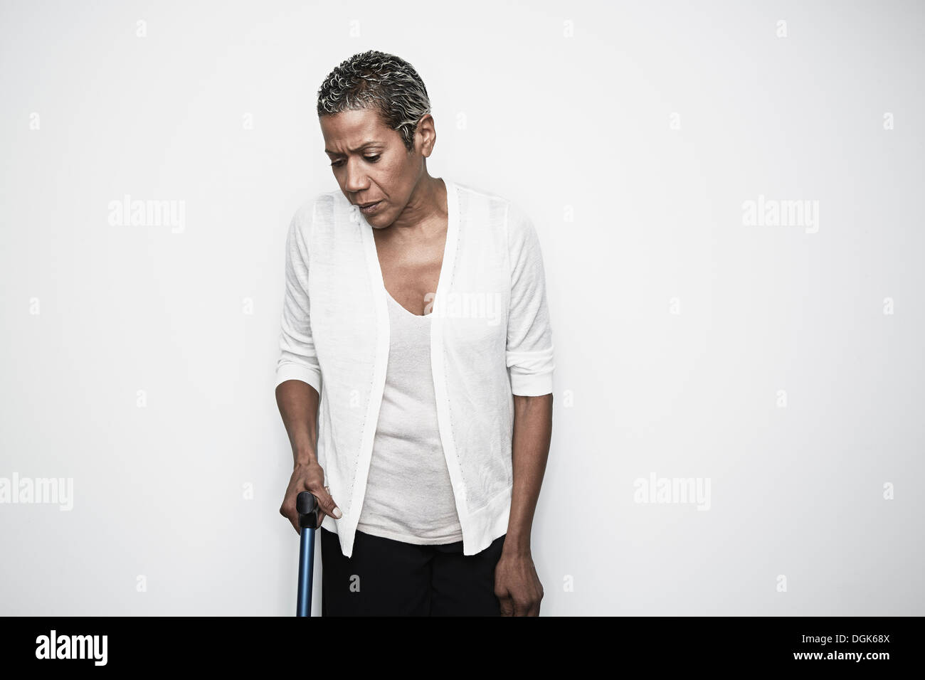 Senior woman using walking stick Stock Photo - Alamy