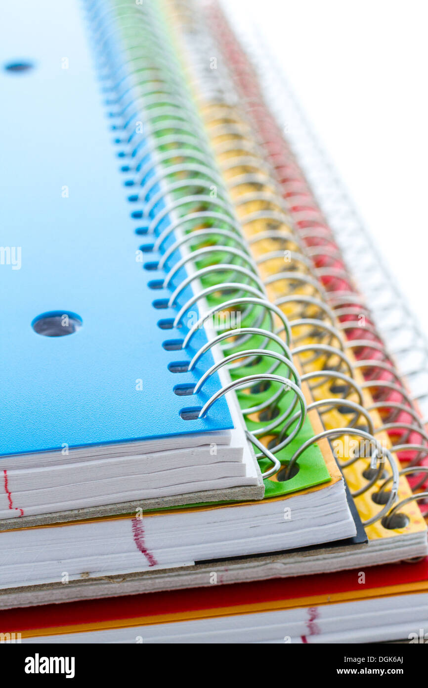 Multicolored spiral notebooks on a white background Stock Photo - Alamy