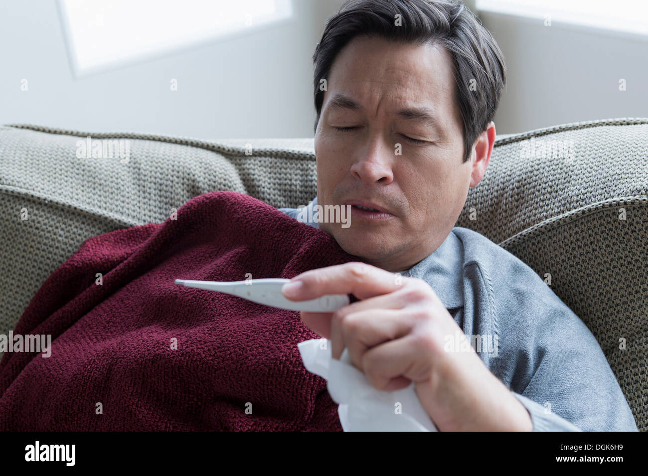 Mature man taking temperature Stock Photo - Alamy