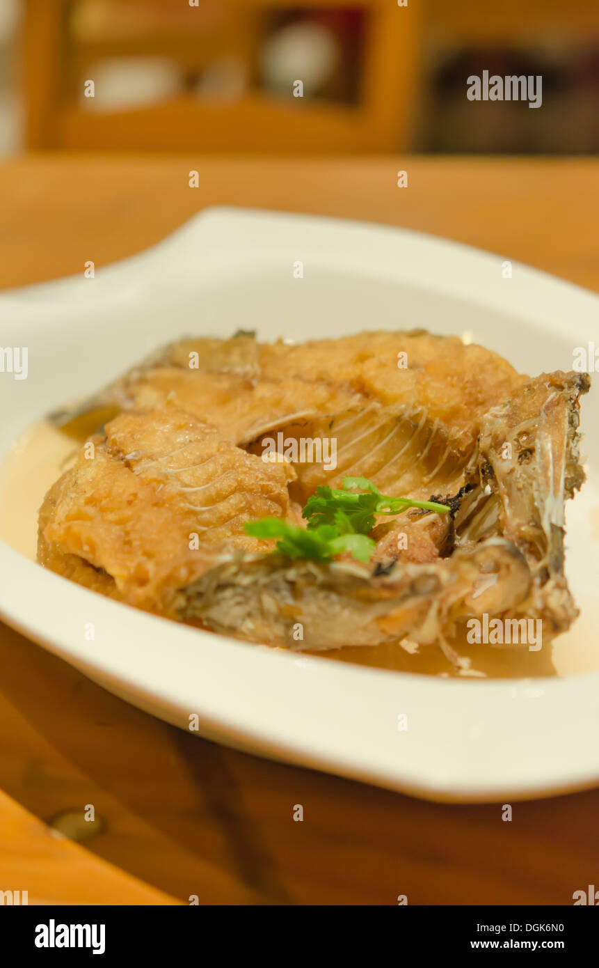 Fish dish - fried fish fillet on white dish Stock Photo - Alamy