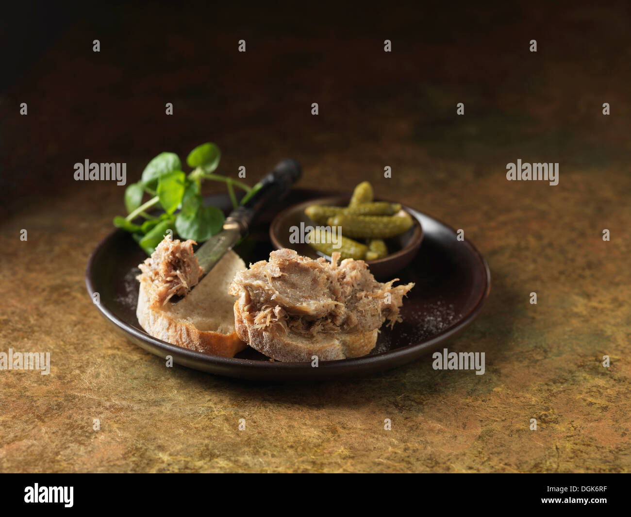 Duck rillette on white toast with pea shoots and cornichons Stock Photo ...