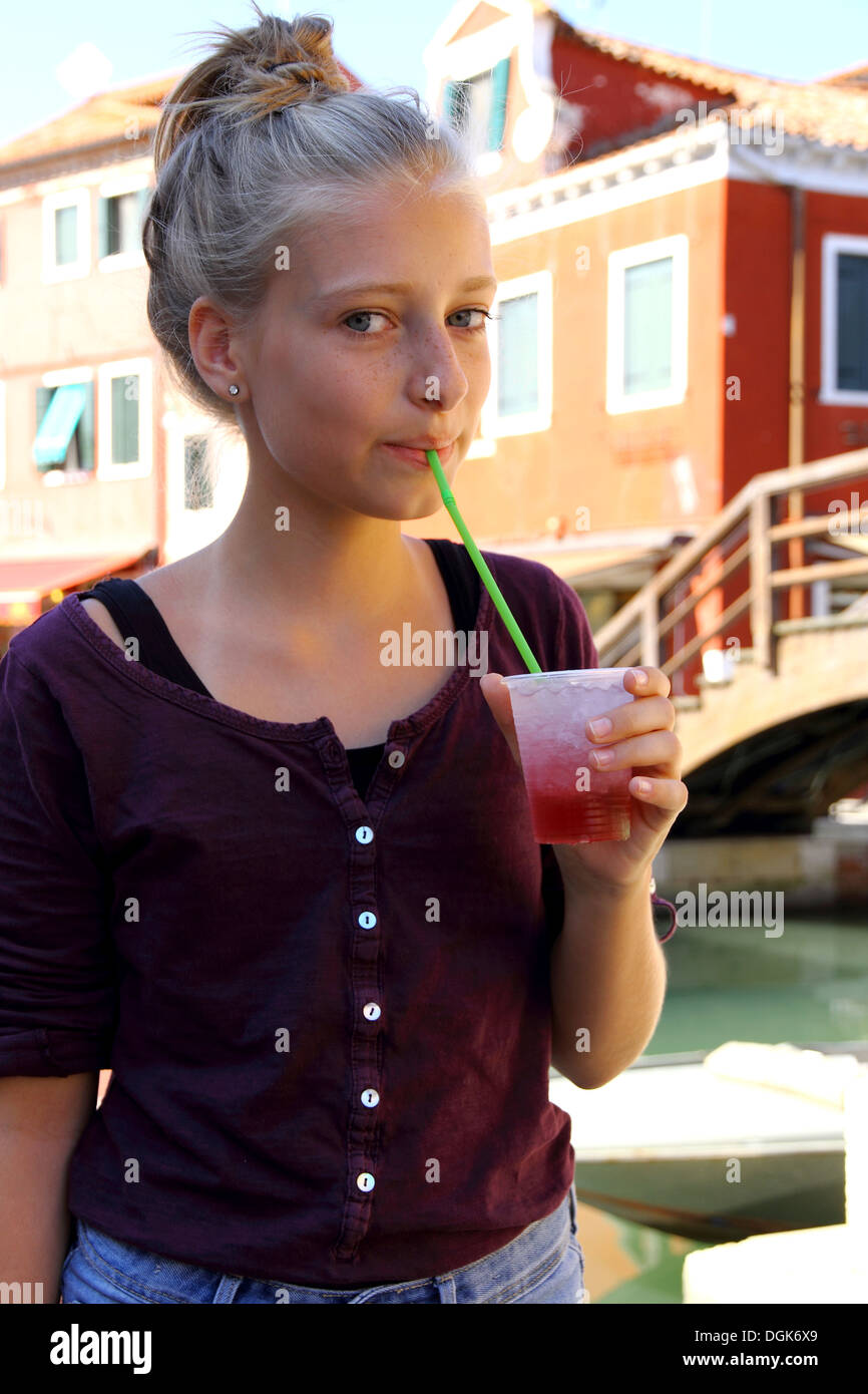 Cute girl with red slush drink, close up Stock Photo - Alamy