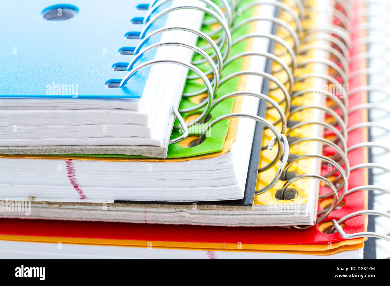 Multicolored spiral notebooks on a white background Stock Photo - Alamy