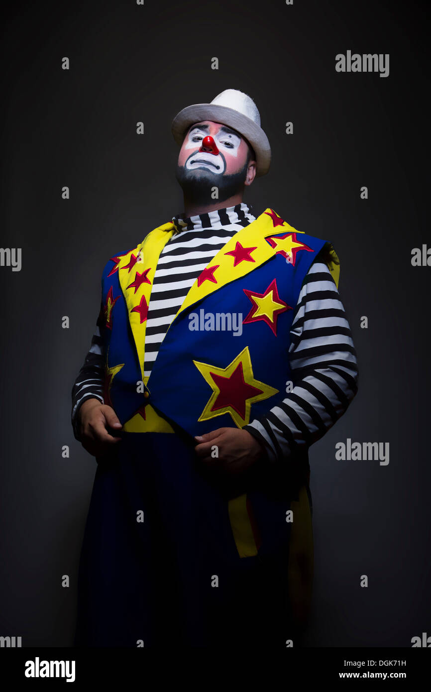 Studio portrait of clown with hands in pockets Stock Photo - Alamy