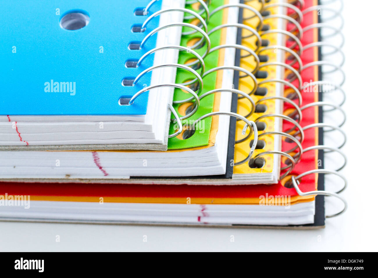 Multicolored spiral notebooks on a white background Stock Photo - Alamy