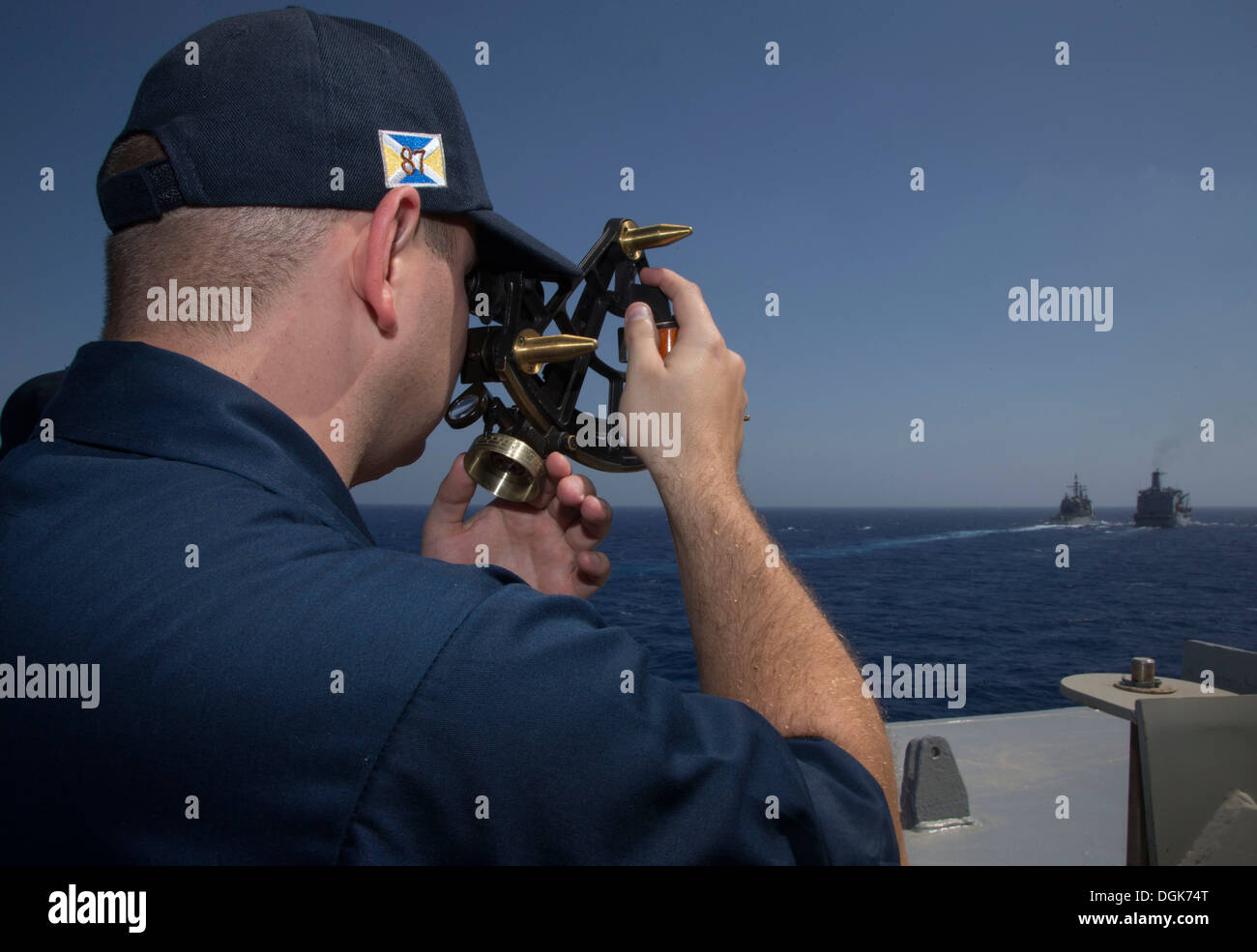 Lt. Matthew Parr uses a sextant aboard the guided-missile destroyer USS ...