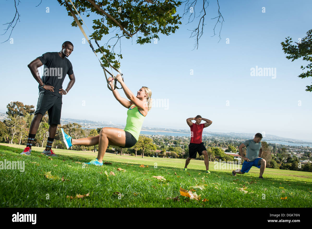 Young woman and trainer with lunge rope in field Stock Photo - Alamy