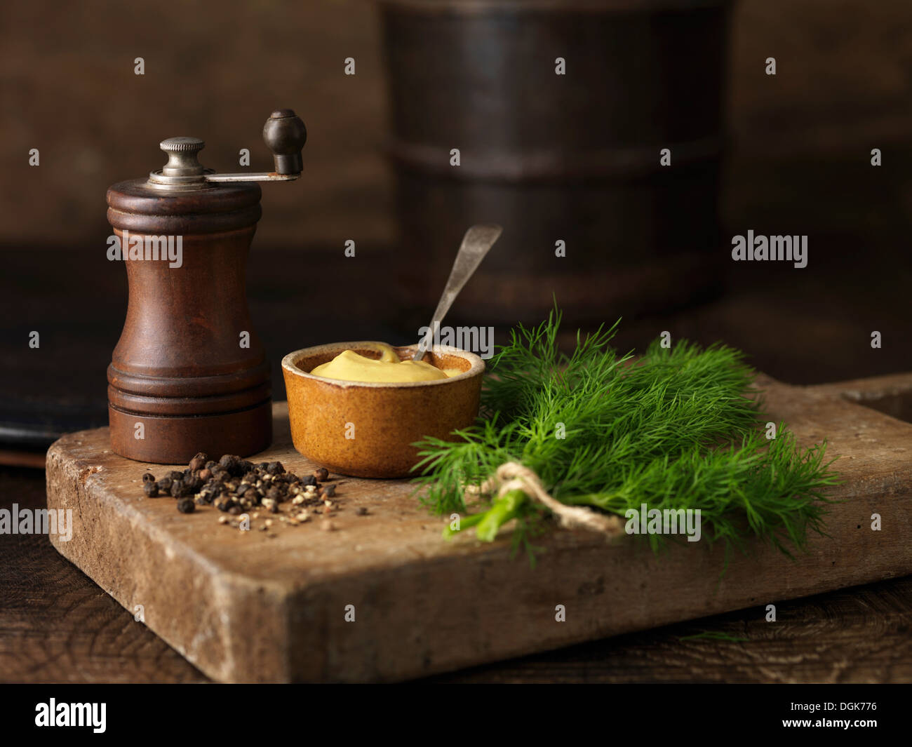 Still life with pepper grinder, dill and mustard (ingredients for ...