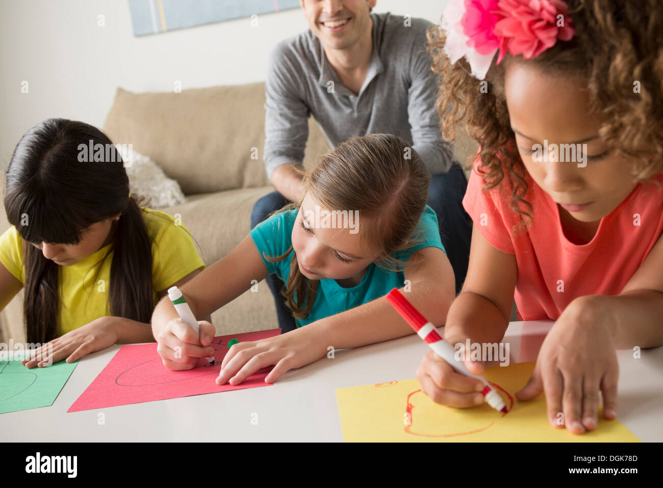 Three girls drawing pictures Stock Photo - Alamy