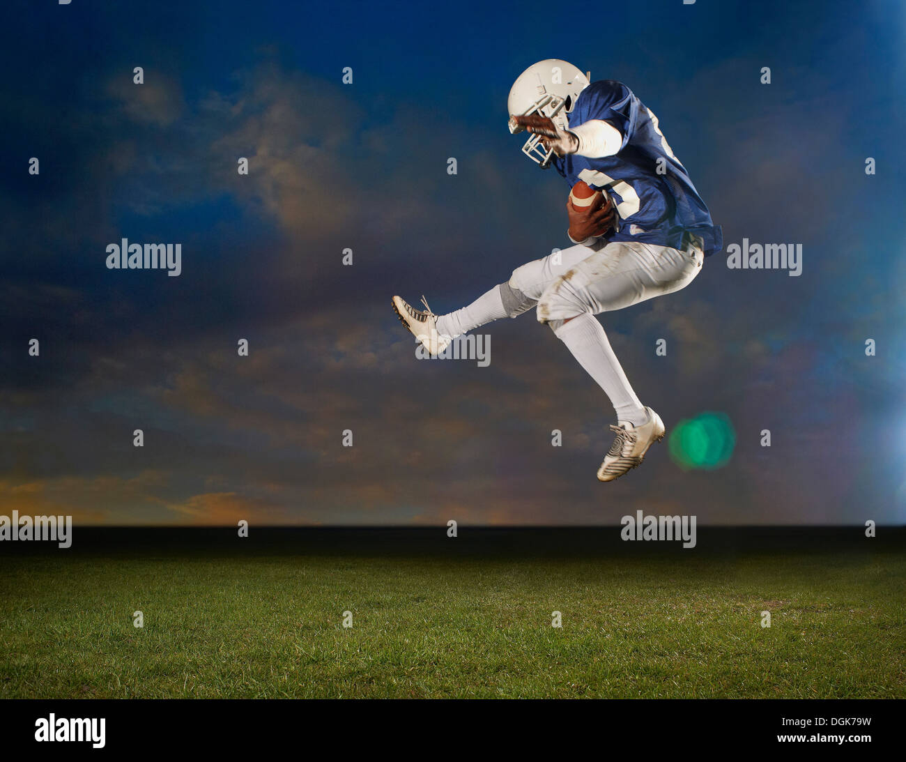 American football player jumping mid air Stock Photo - Alamy