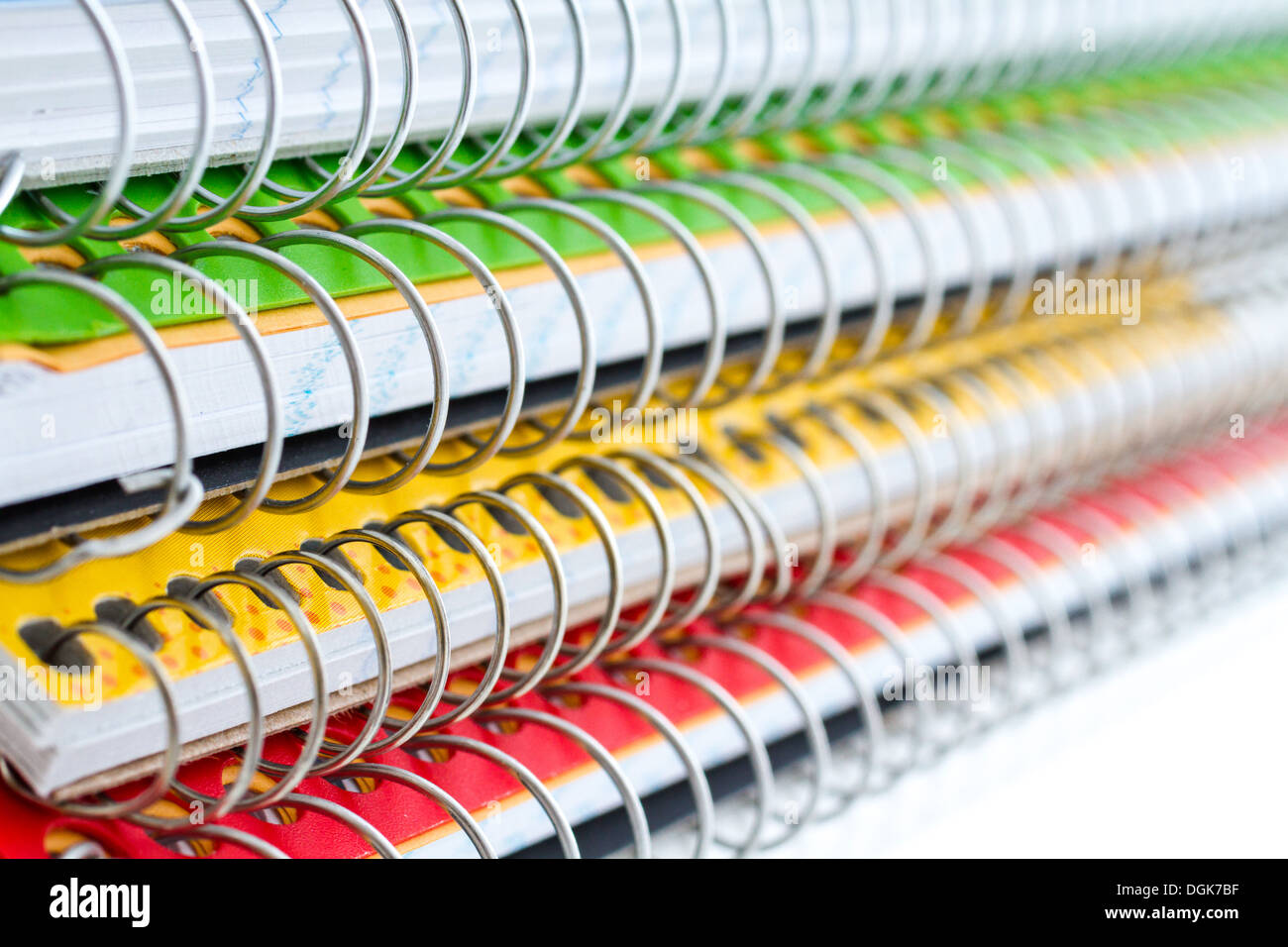 Multicolored spiral notebooks on a white background Stock Photo - Alamy
